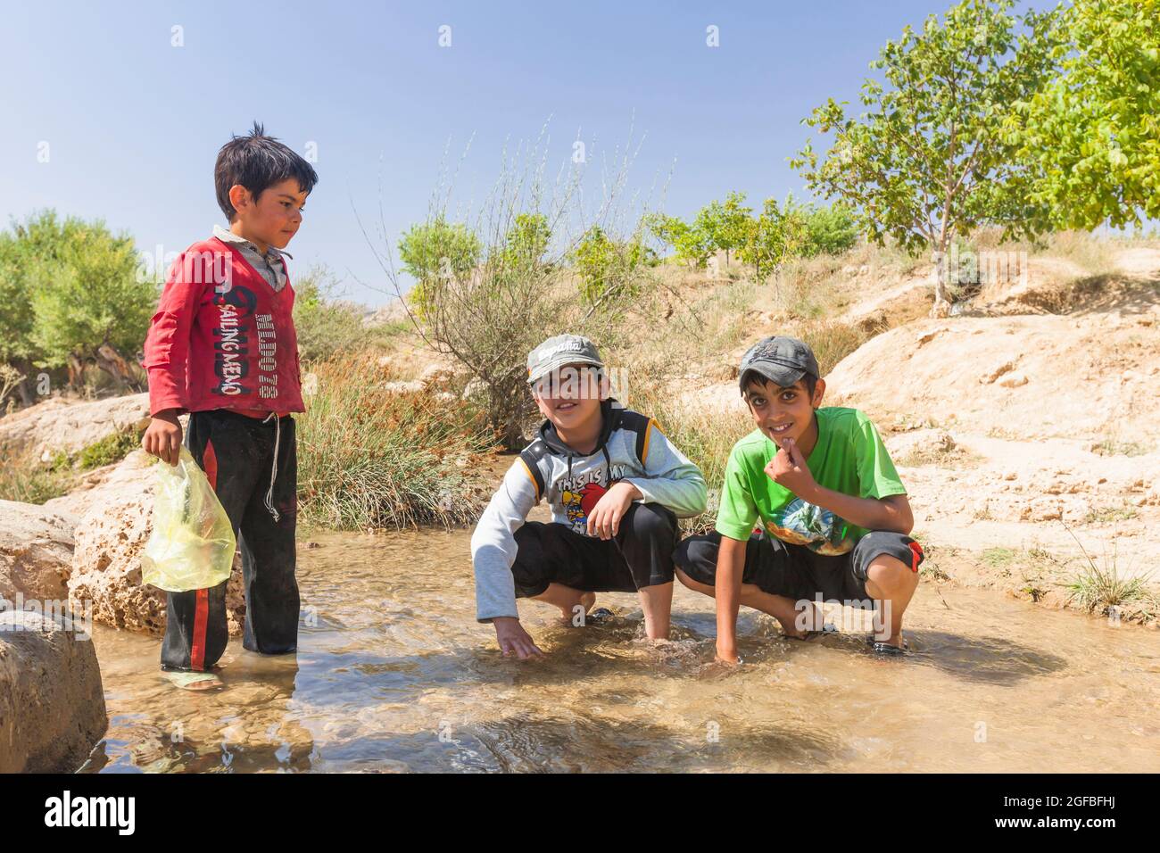 Boys playing at the river in highland, Road 78, Zagros mountains, Islam ...