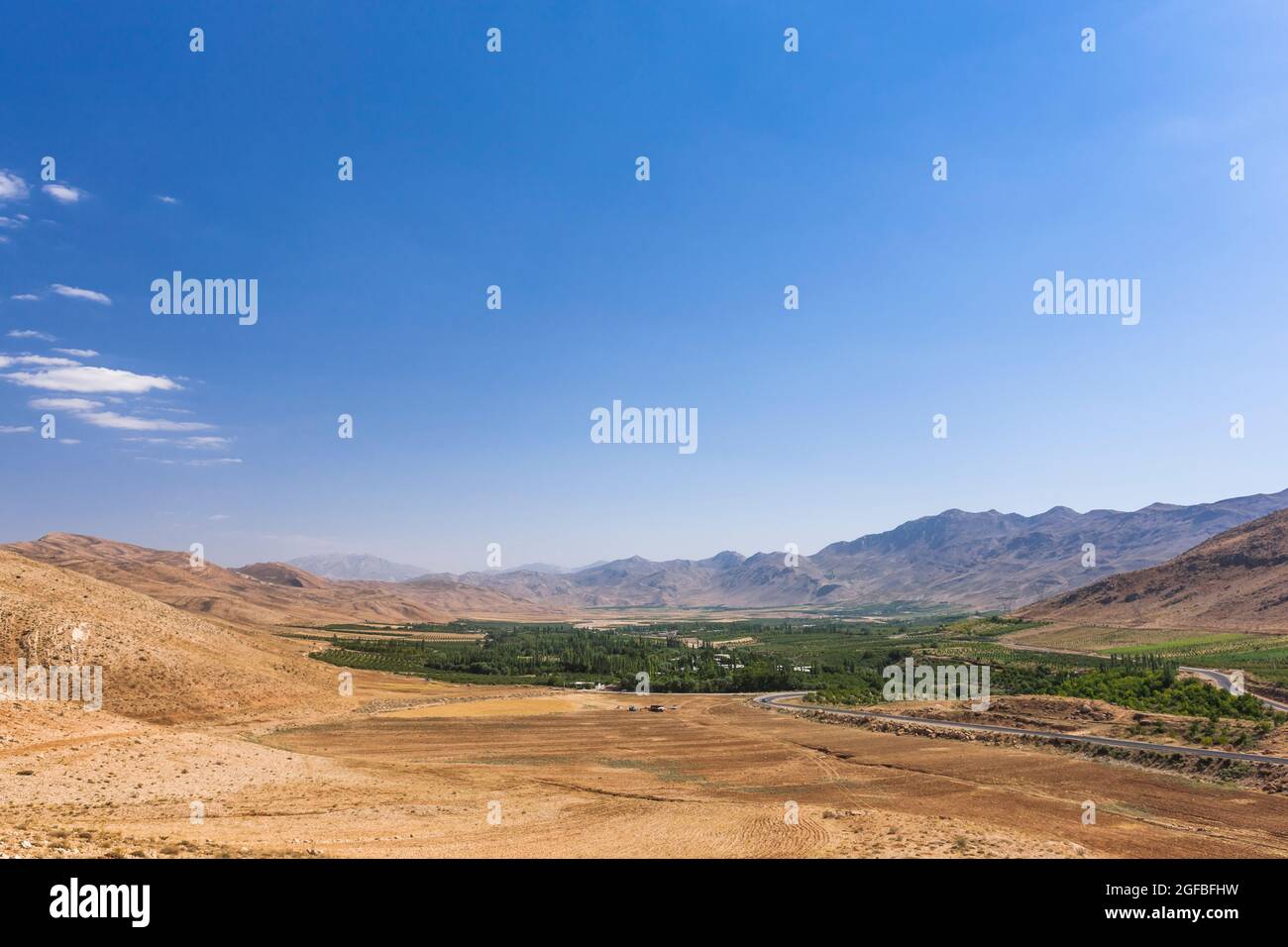 View of agricaltural field and village on highland, Road 78, Zagros ...