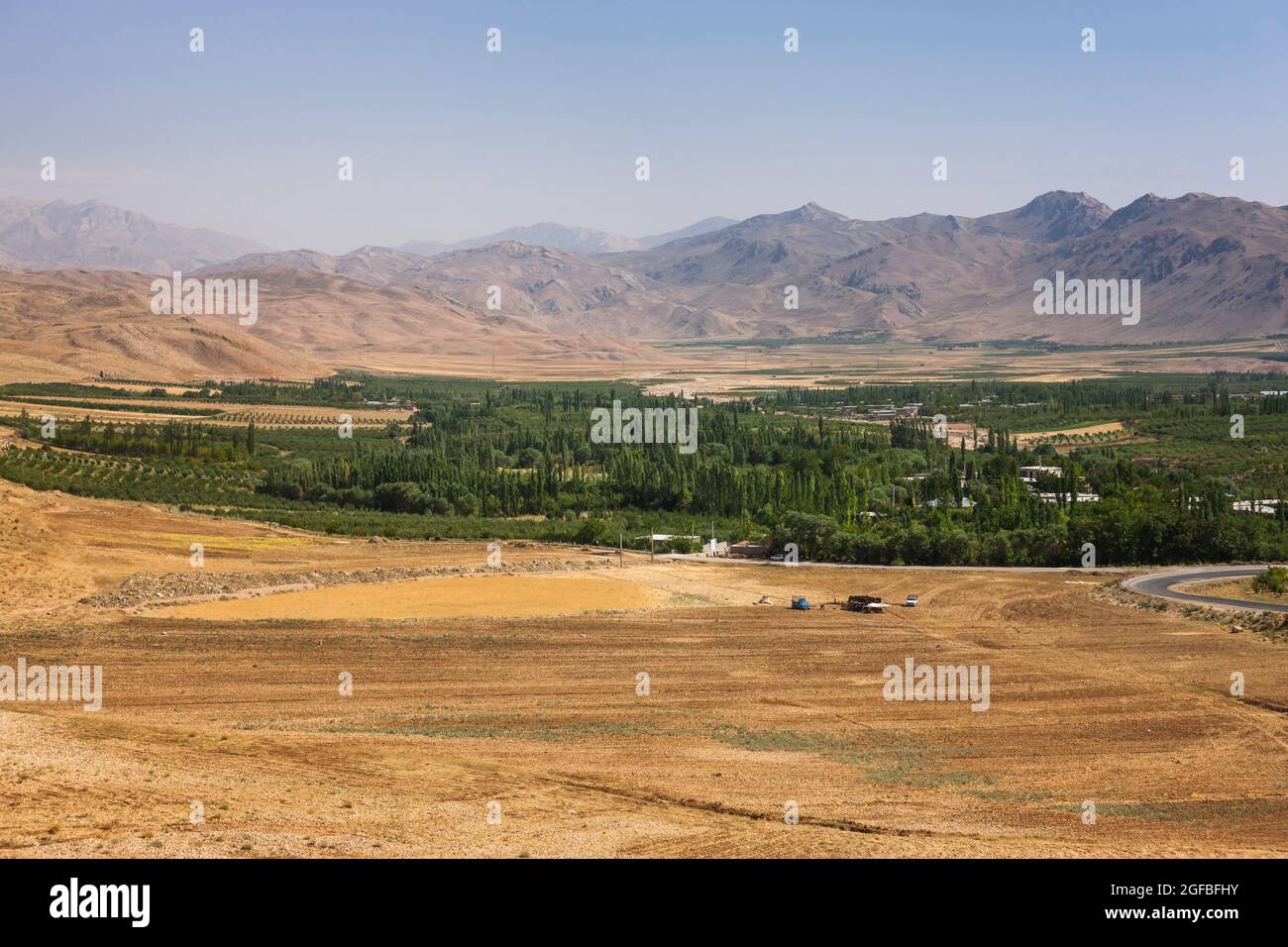 View of agricaltural field and village on highland, Road 78, Zagros ...
