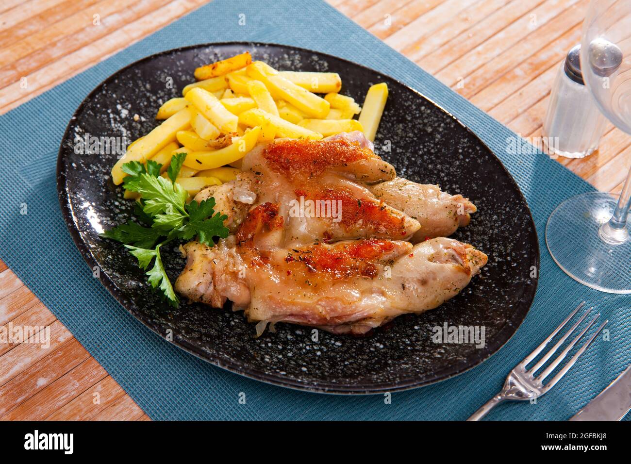 Appetizing fried pig legs with potatoes served on plate Stock Photo - Alamy