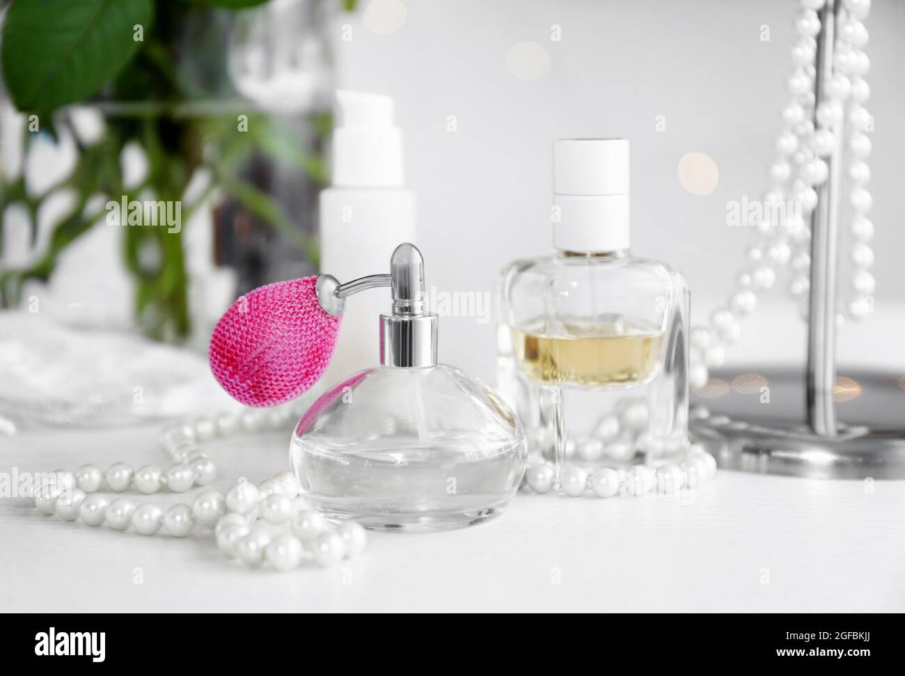 Perfume on light dressing table Stock Photo - Alamy