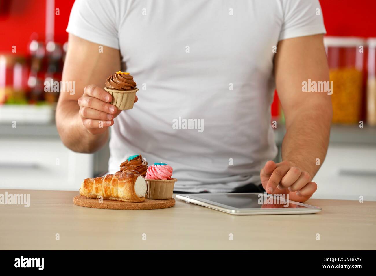 Man counting calories on tablet Stock Photo - Alamy