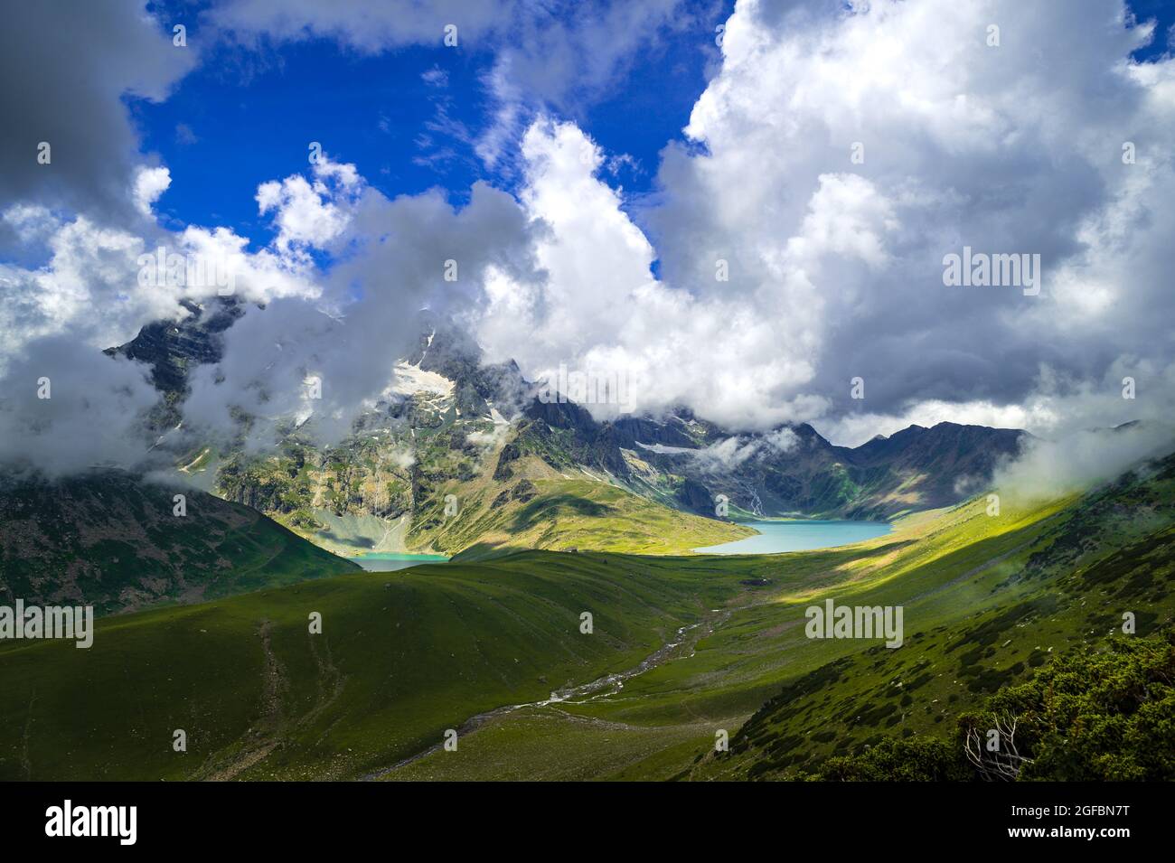 Landscape with clouds. Gangabal Lake and Nundkol Lake at the base of ...