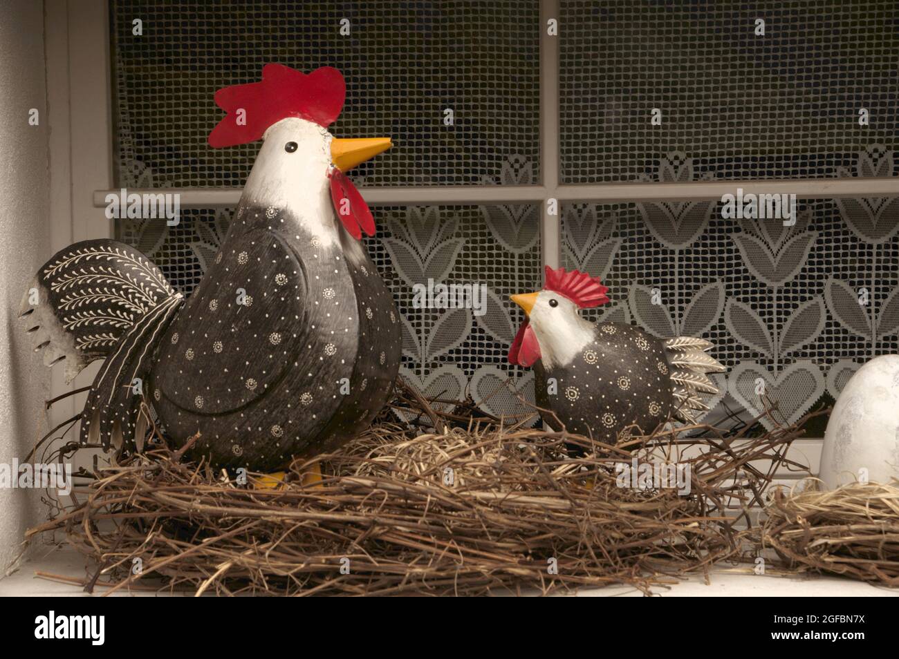 Metal chicken ornaments displayed on Swiss window-ledge Stock Photo - Alamy