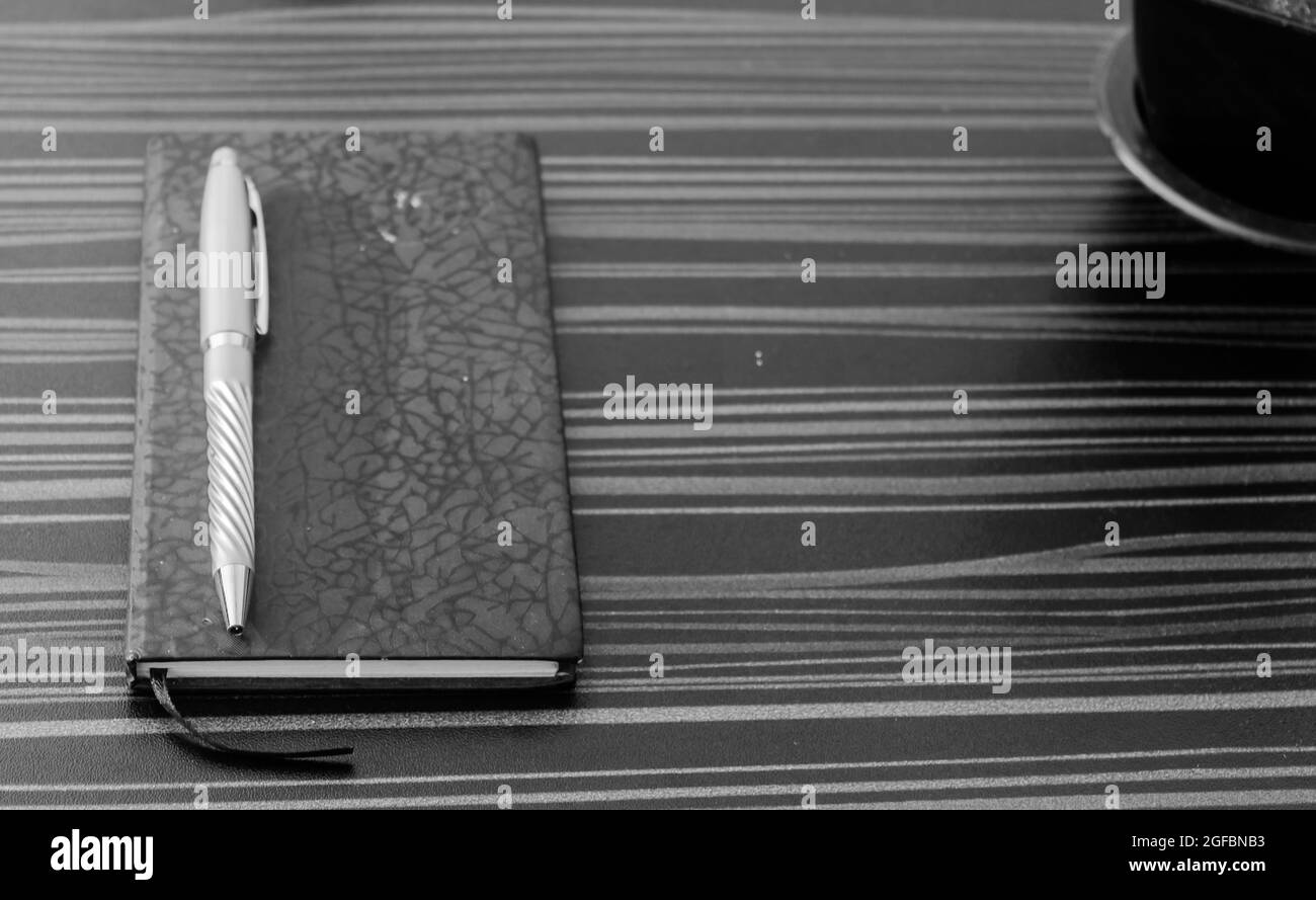Pen and notebook on office table. Table top view. Corporate business ...