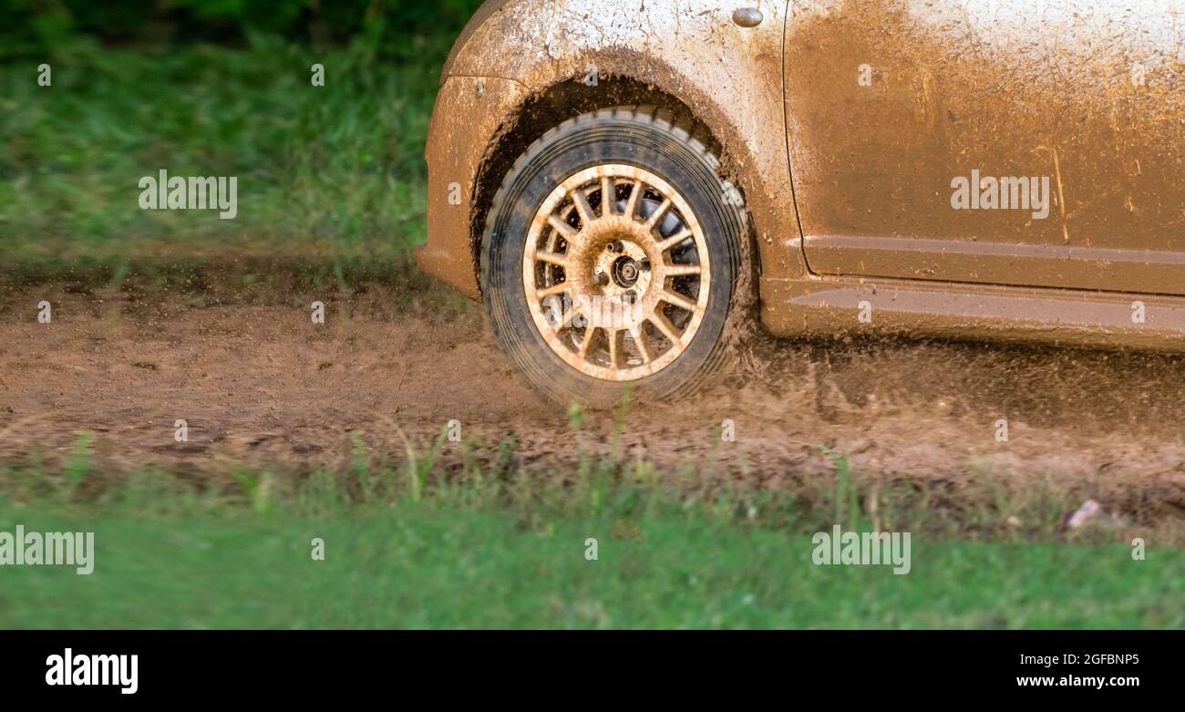 Rally racing car on muddy track Stock Photo - Alamy