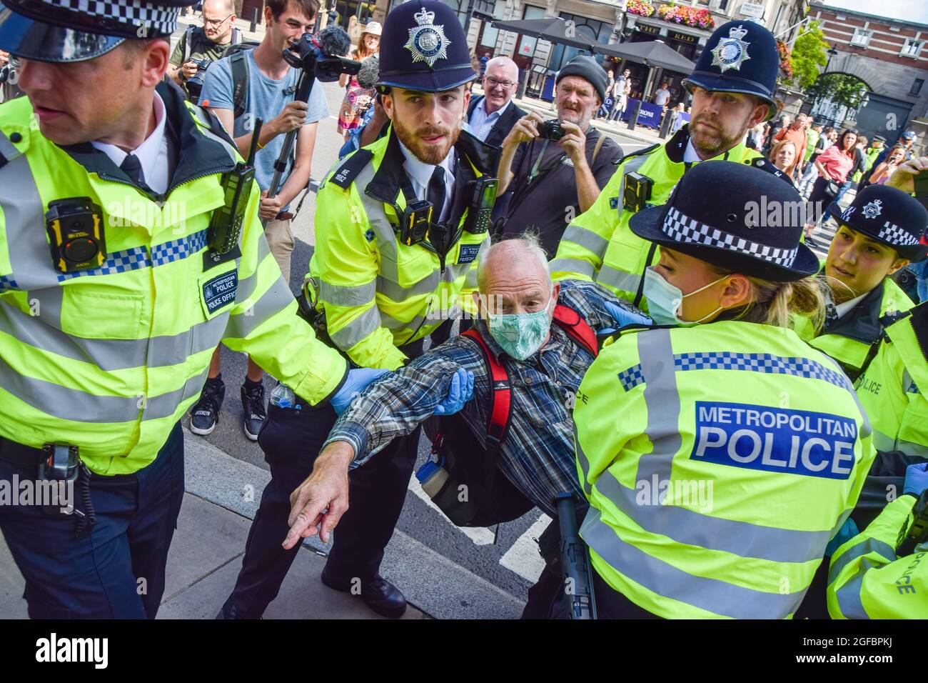 London, UK. 24th Aug, 2021. Police arrest a demonstrator who stuck ...