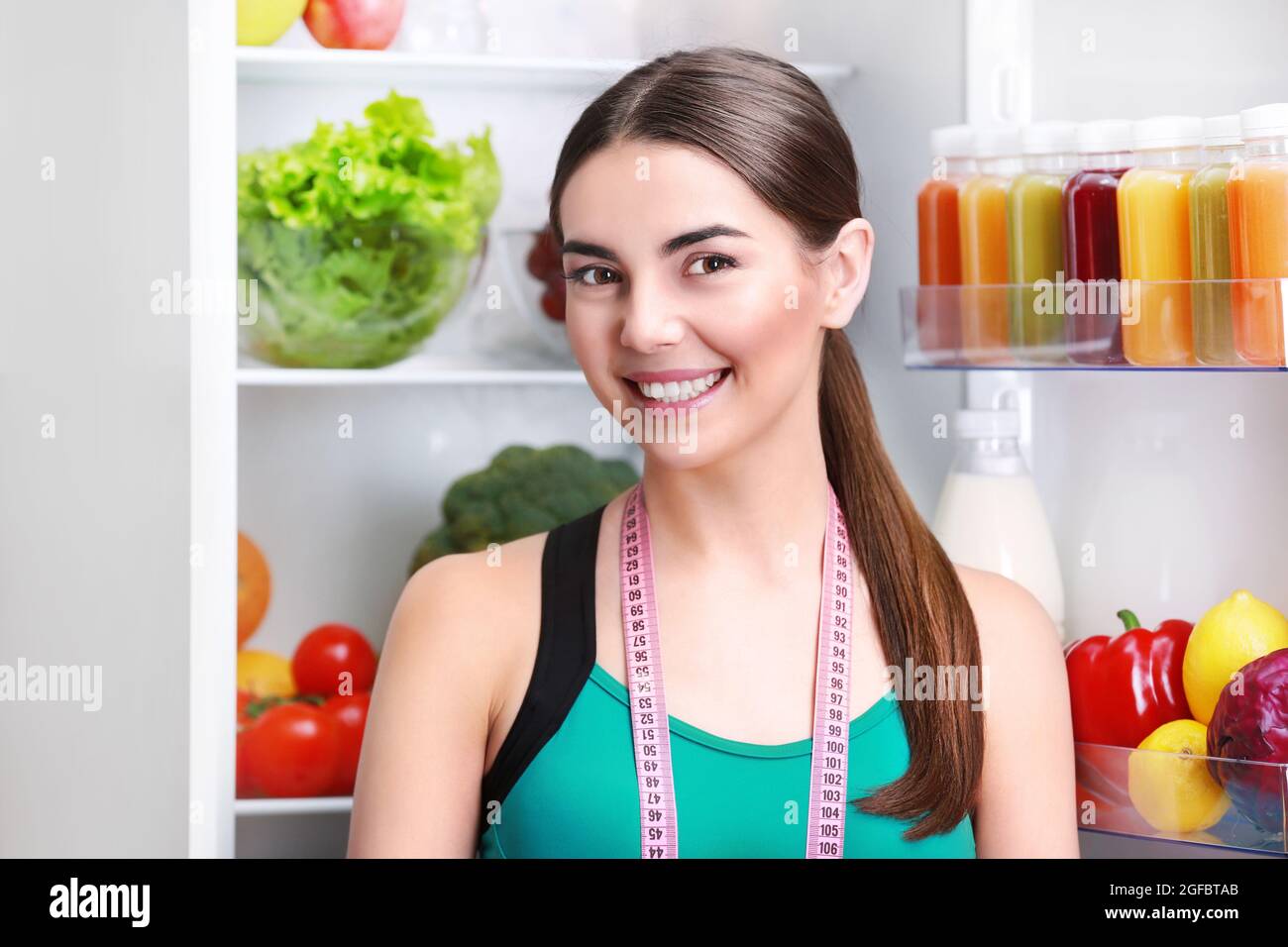 Young woman with tape line on her neck standing beside fridge Stock ...