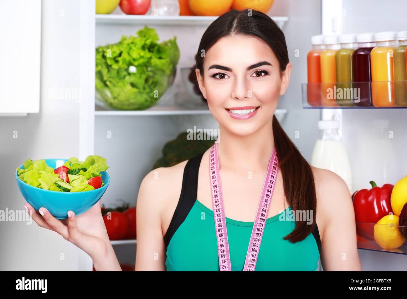 Young woman with tape line on her neck standing beside fridge Stock ...