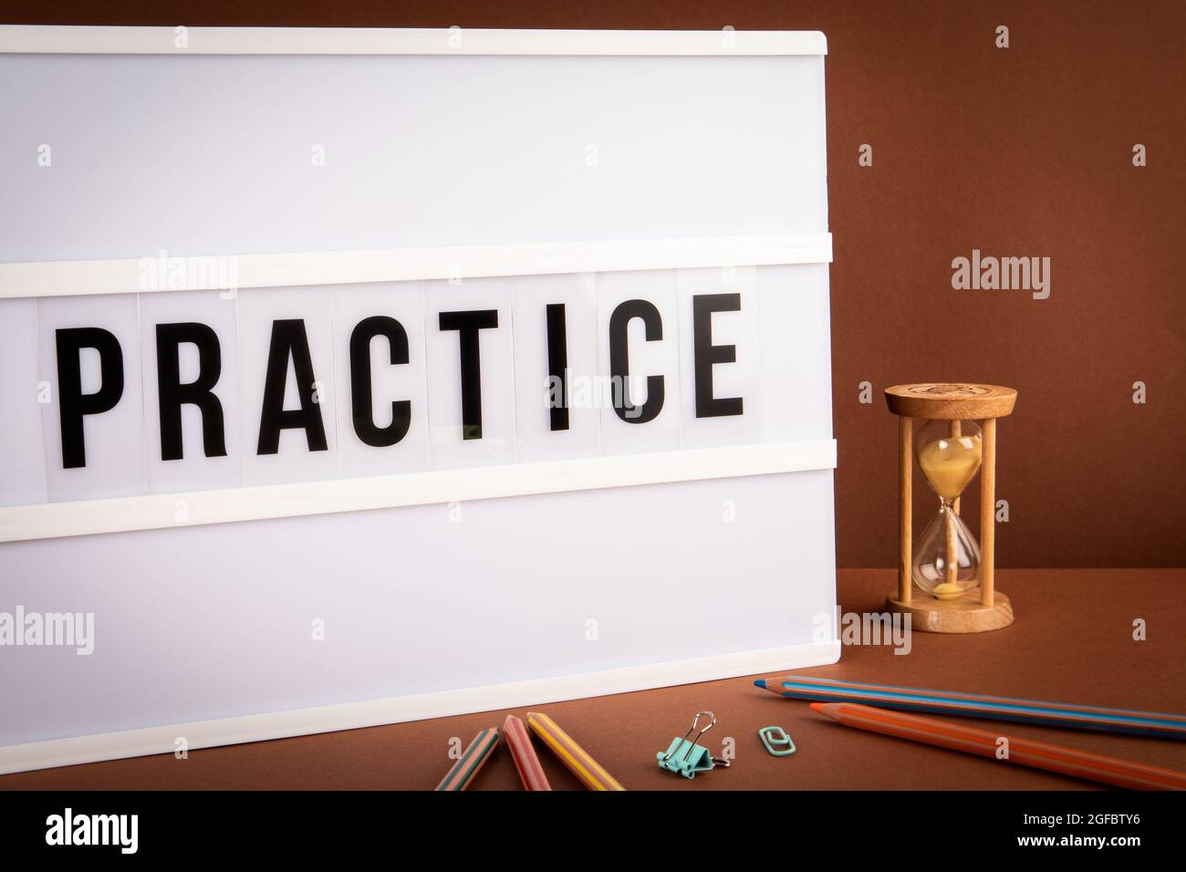Practice. Light box on a brown office desk Stock Photo - Alamy