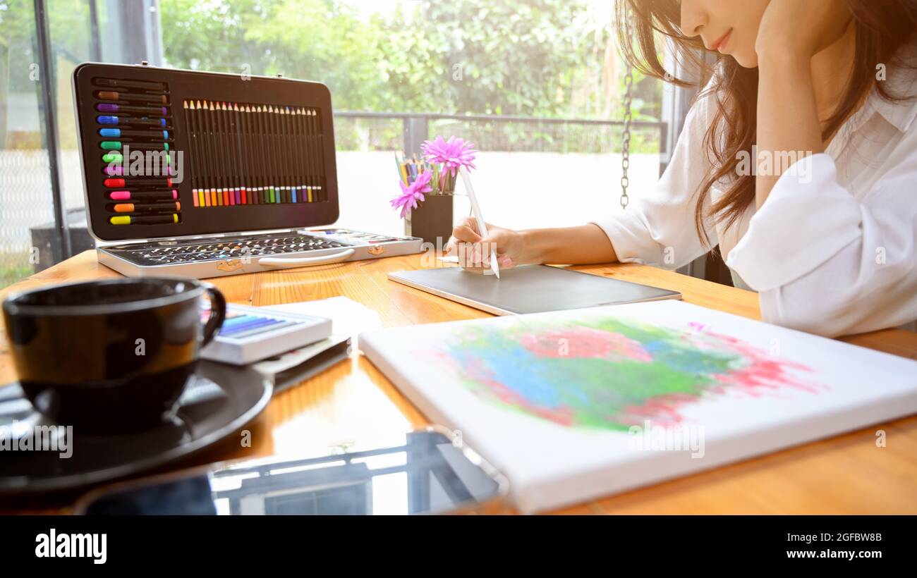 Cropped shot, Attractive graphic art designer using stylus to create ...