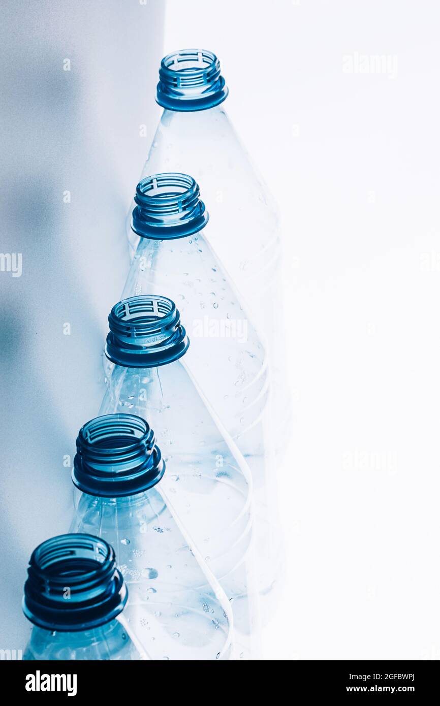 Used transparent plastic bottles on light blue background. Group of ...