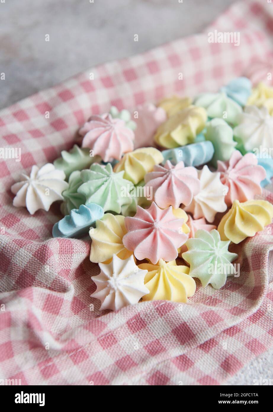 Close-up delicious meringue cookies pastel colors. French pastries ...