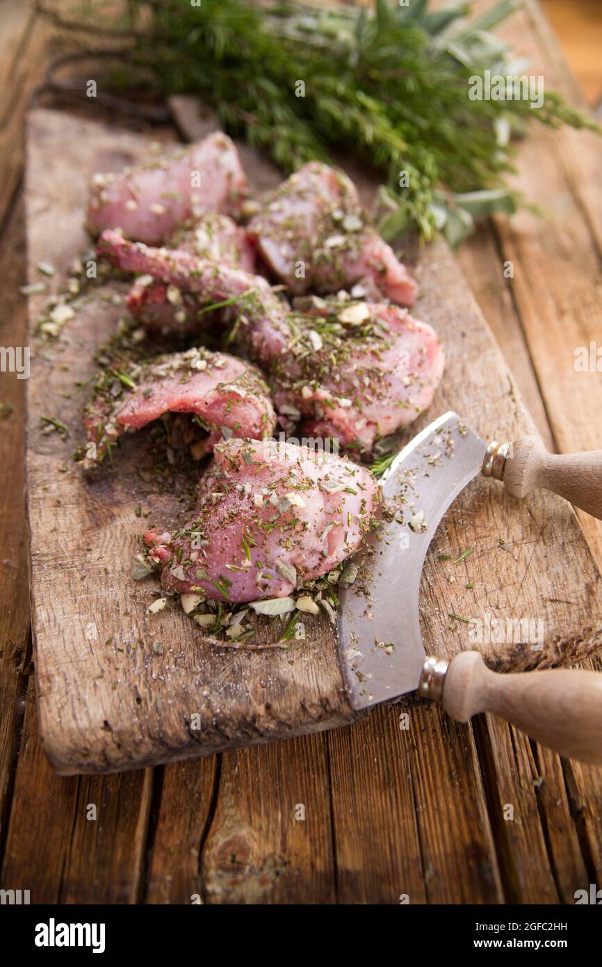 Preparation with chopped aromatic Mediterranean herbs of raw rabbit ...