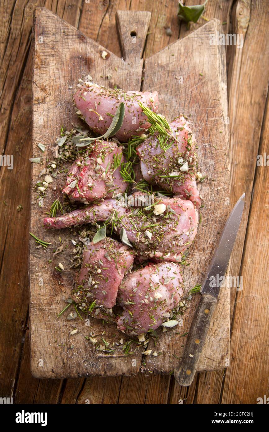 Preparation with chopped aromatic Mediterranean herbs of raw rabbit ...