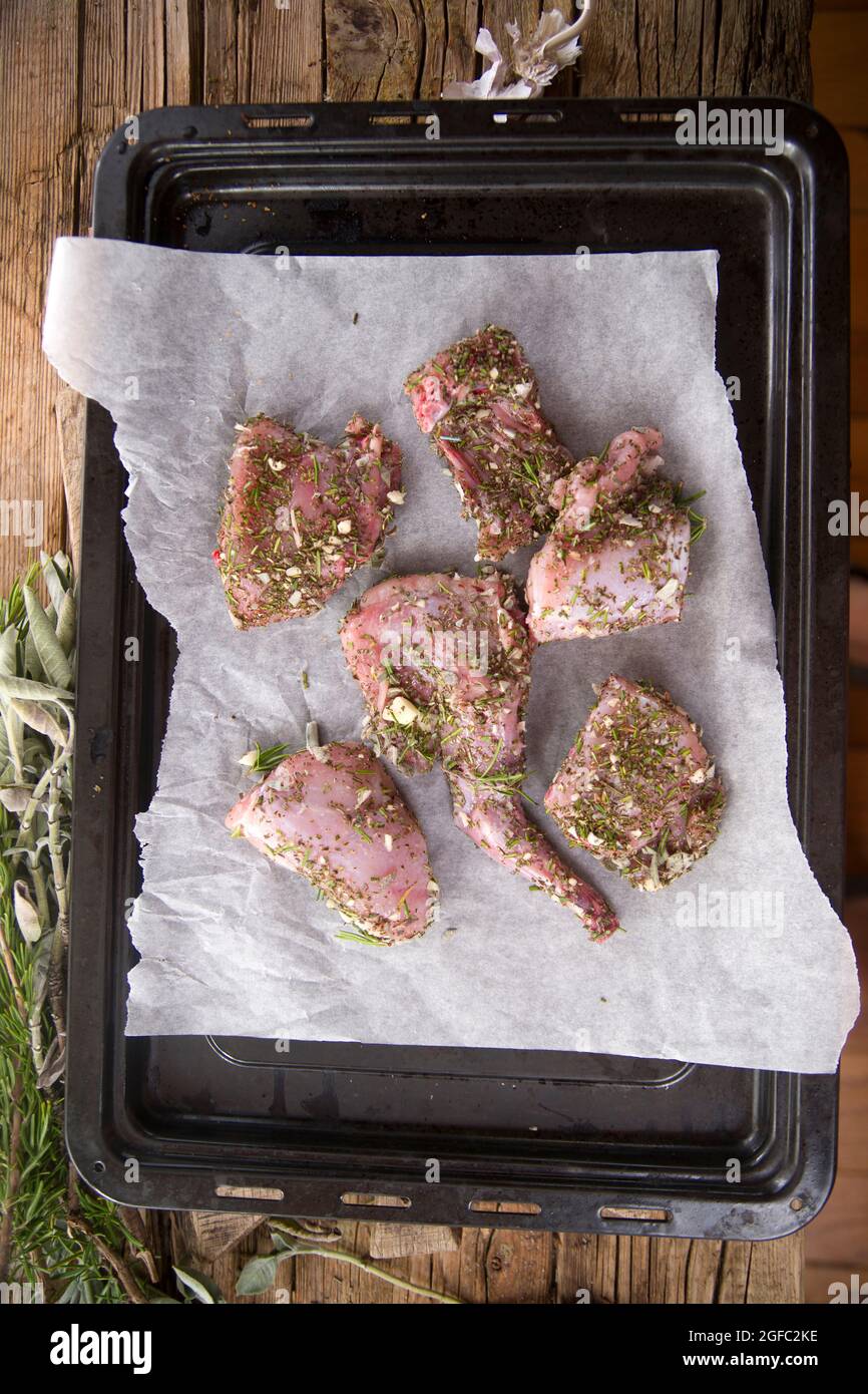 Preparation with chopped aromatic Mediterranean herbs of raw rabbit ...