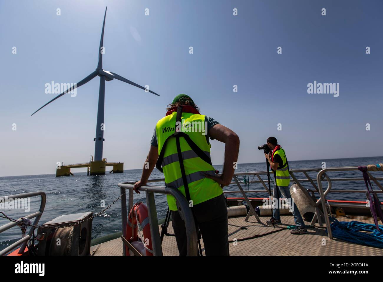 Cameramen are seen taking images of the wind turbines off the coast of ...