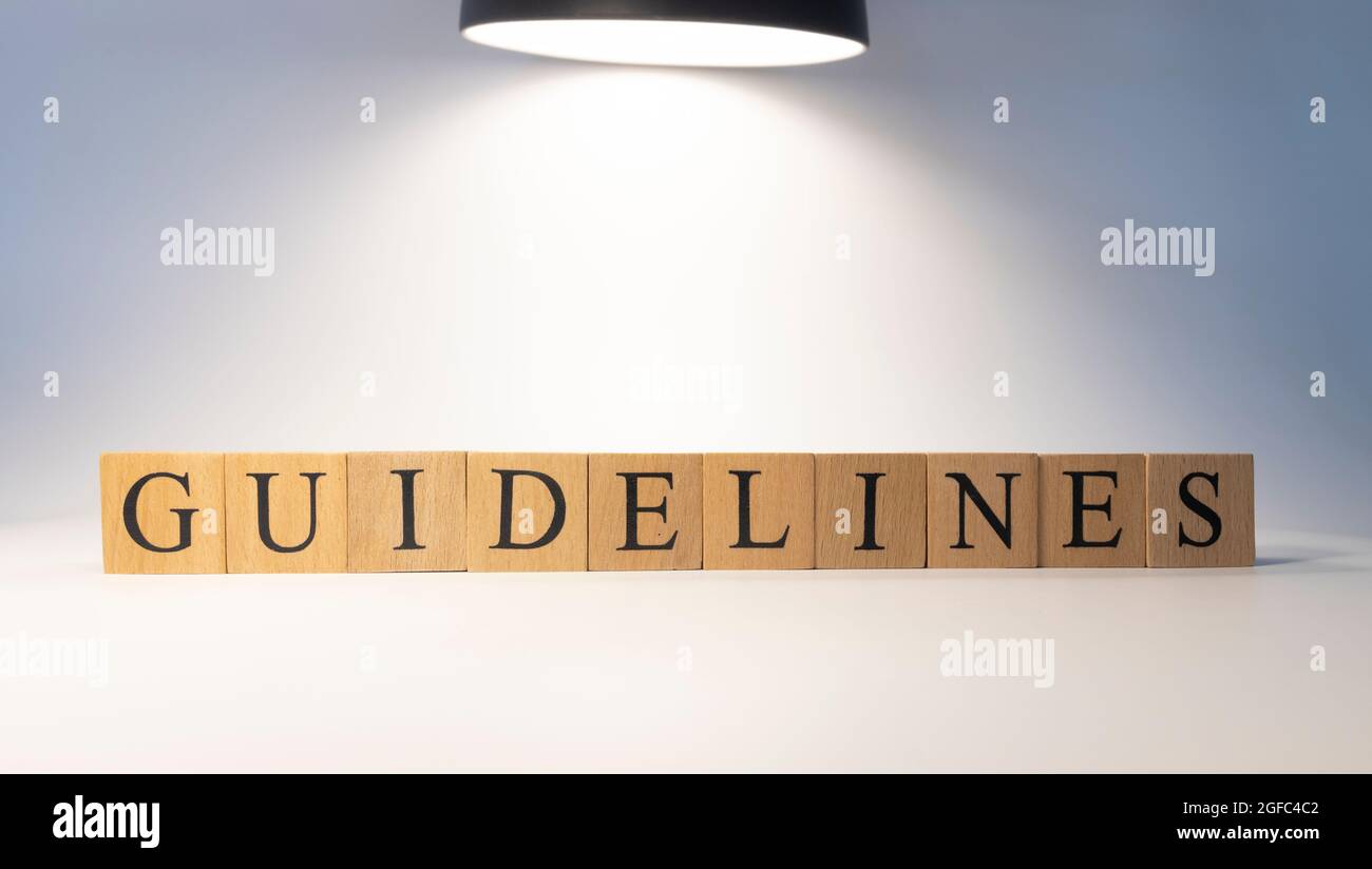 Word Guidelines crafted from wooden cubesfinance and business. Close-up ...