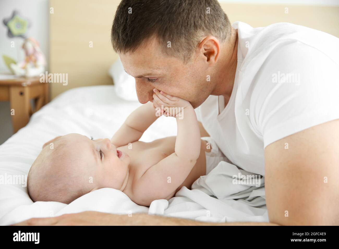 Father playing with smiling baby Stock Photo - Alamy