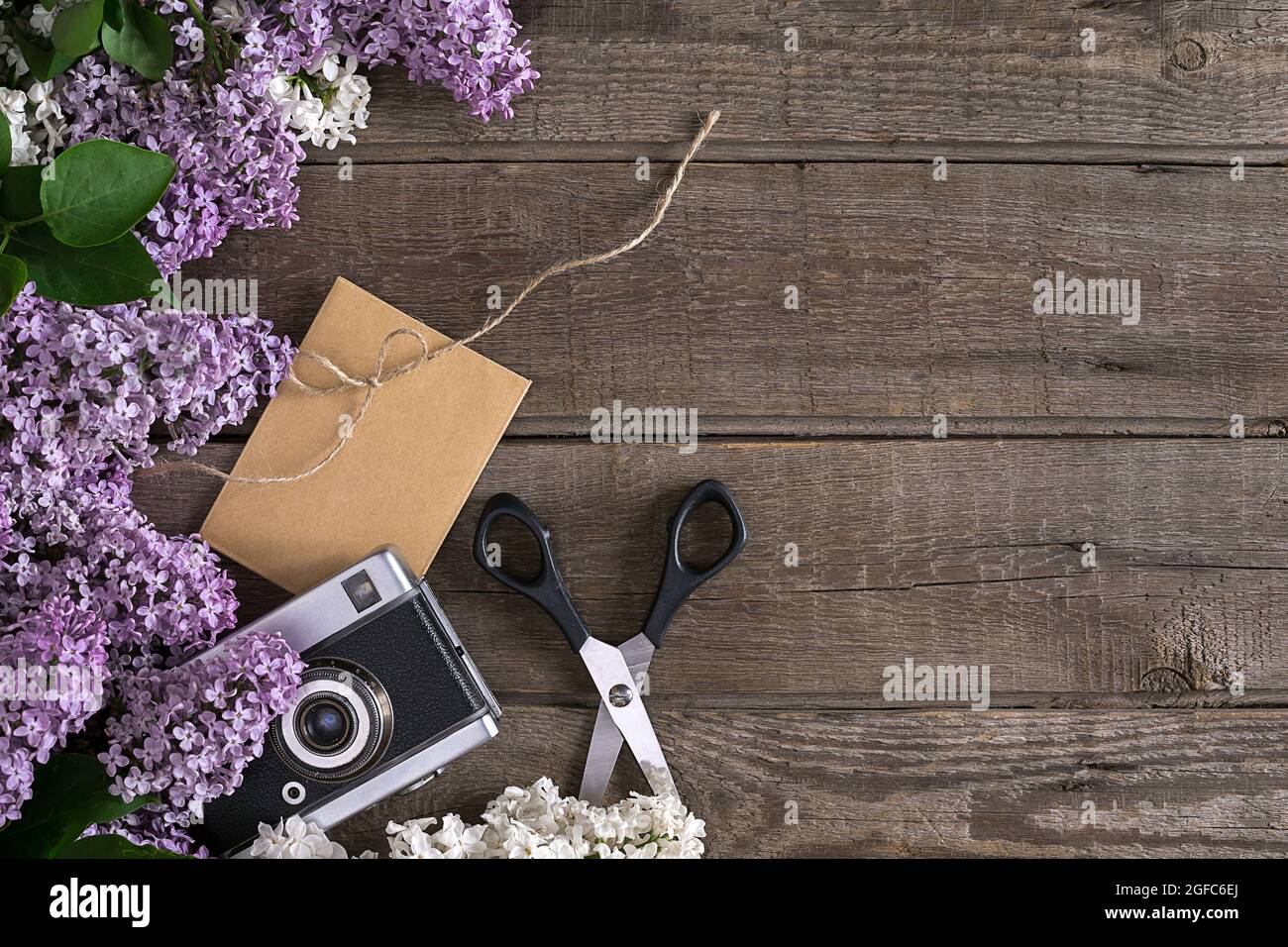 Lilac blossom on rustic wooden background with empty space for greeting ...