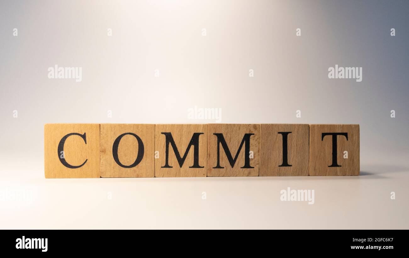 The word Commit was created from wooden cubes Stock Photo - Alamy