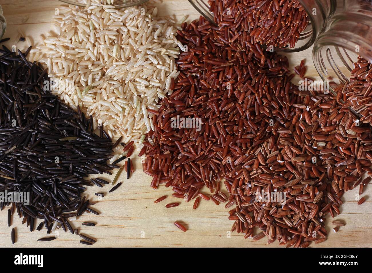 Black Wild Rice on Wooden Table with brown rice and Himalayan red Stock ...