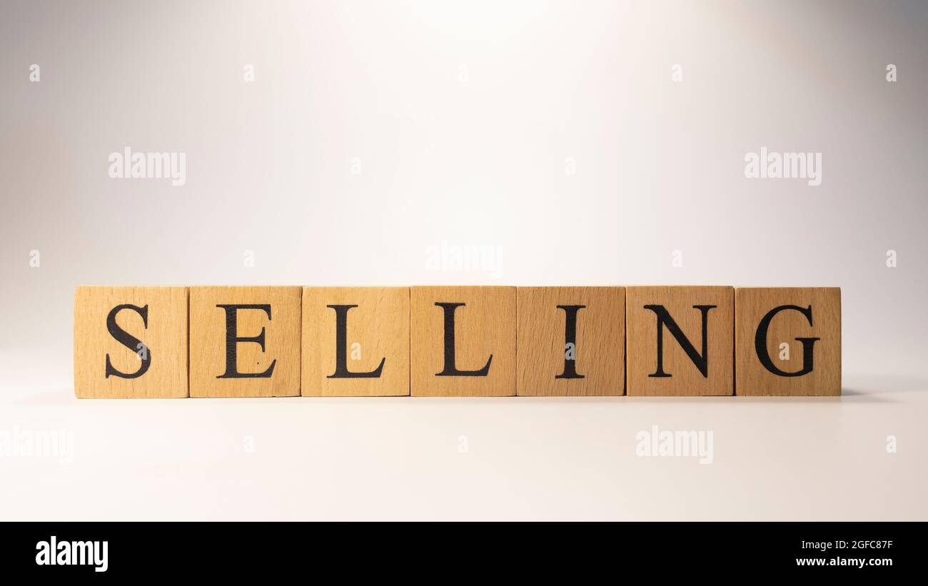 The word selling was created from wooden cubes. Economy and Shopping ...