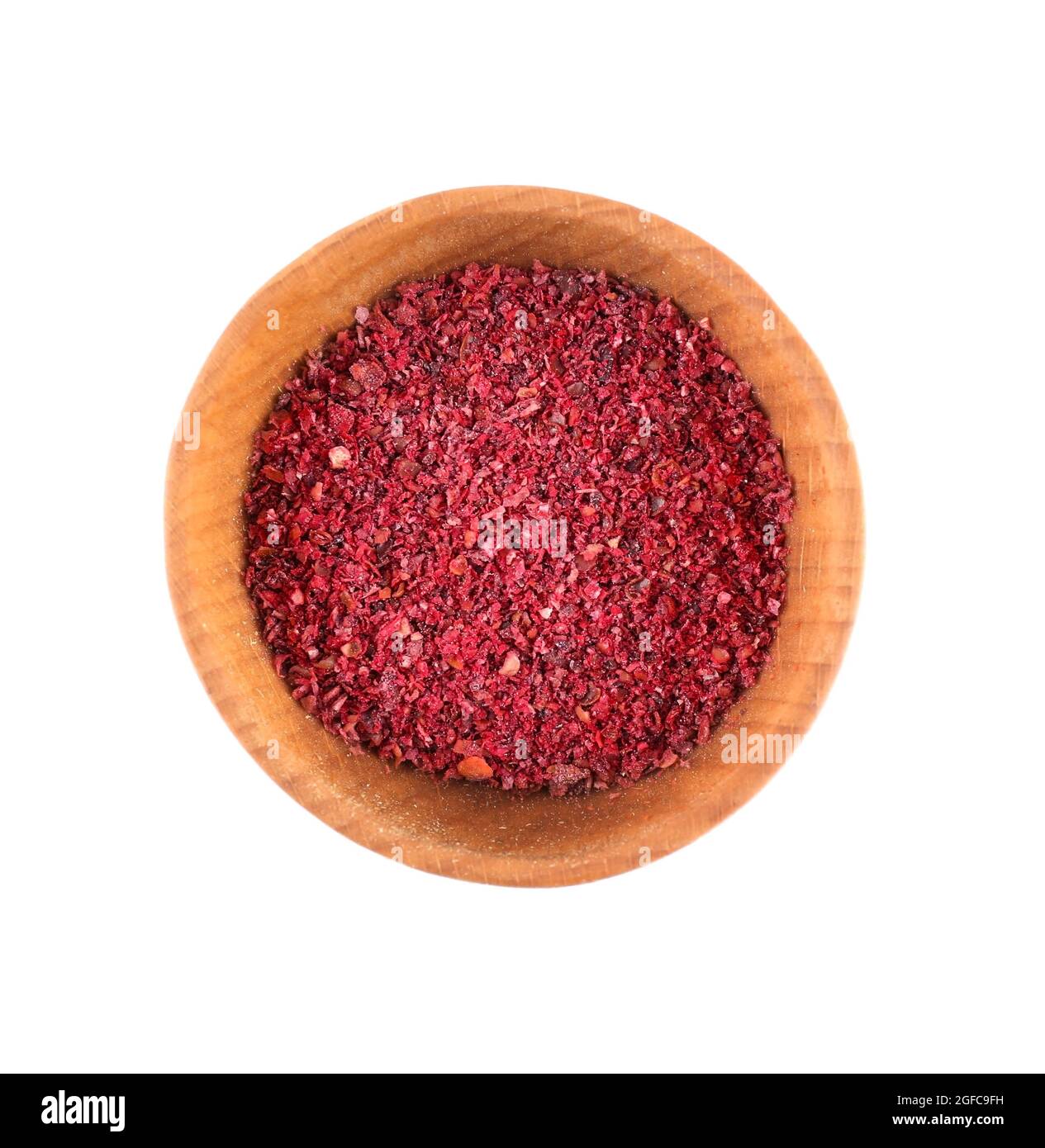 Dried sumac in small wooden bowl isolated on white Stock Photo - Alamy