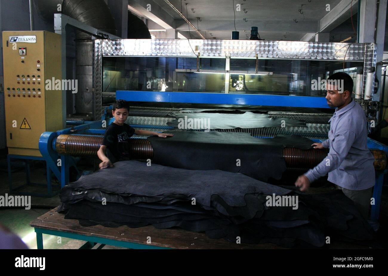 Men cutting cloth at a big garment factory. Bangladesh Stock Photo - Alamy