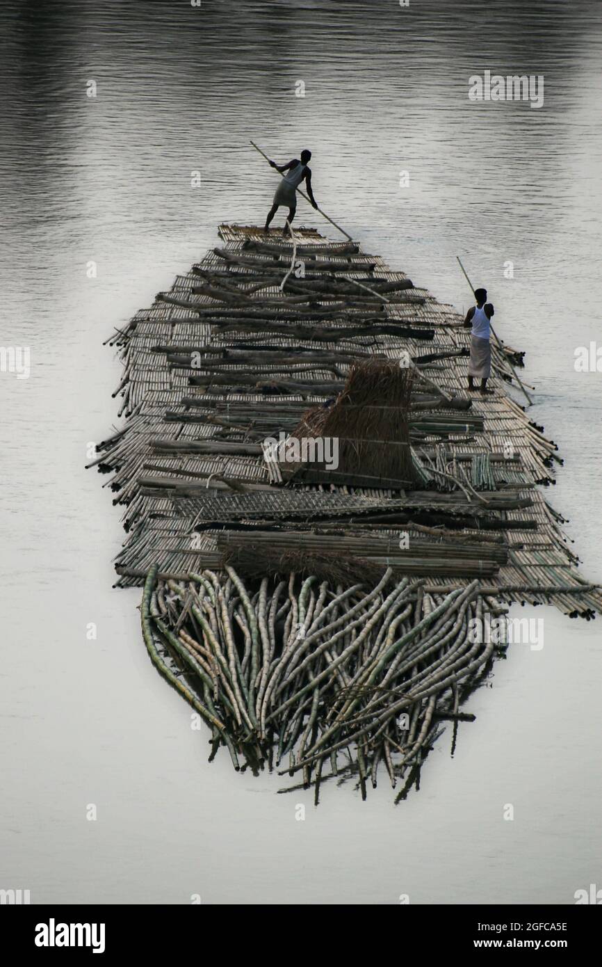 Men collecting bamboo on a handmade Bamboo raft. Bangladesh Stock Photo ...