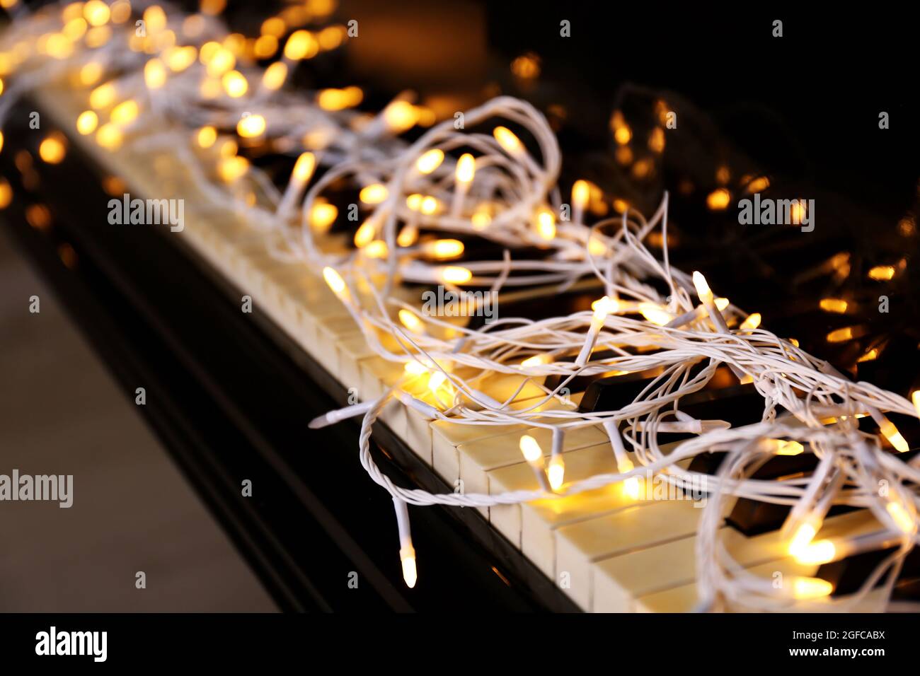 Christmas lights on piano keys, closeup Stock Photo - Alamy