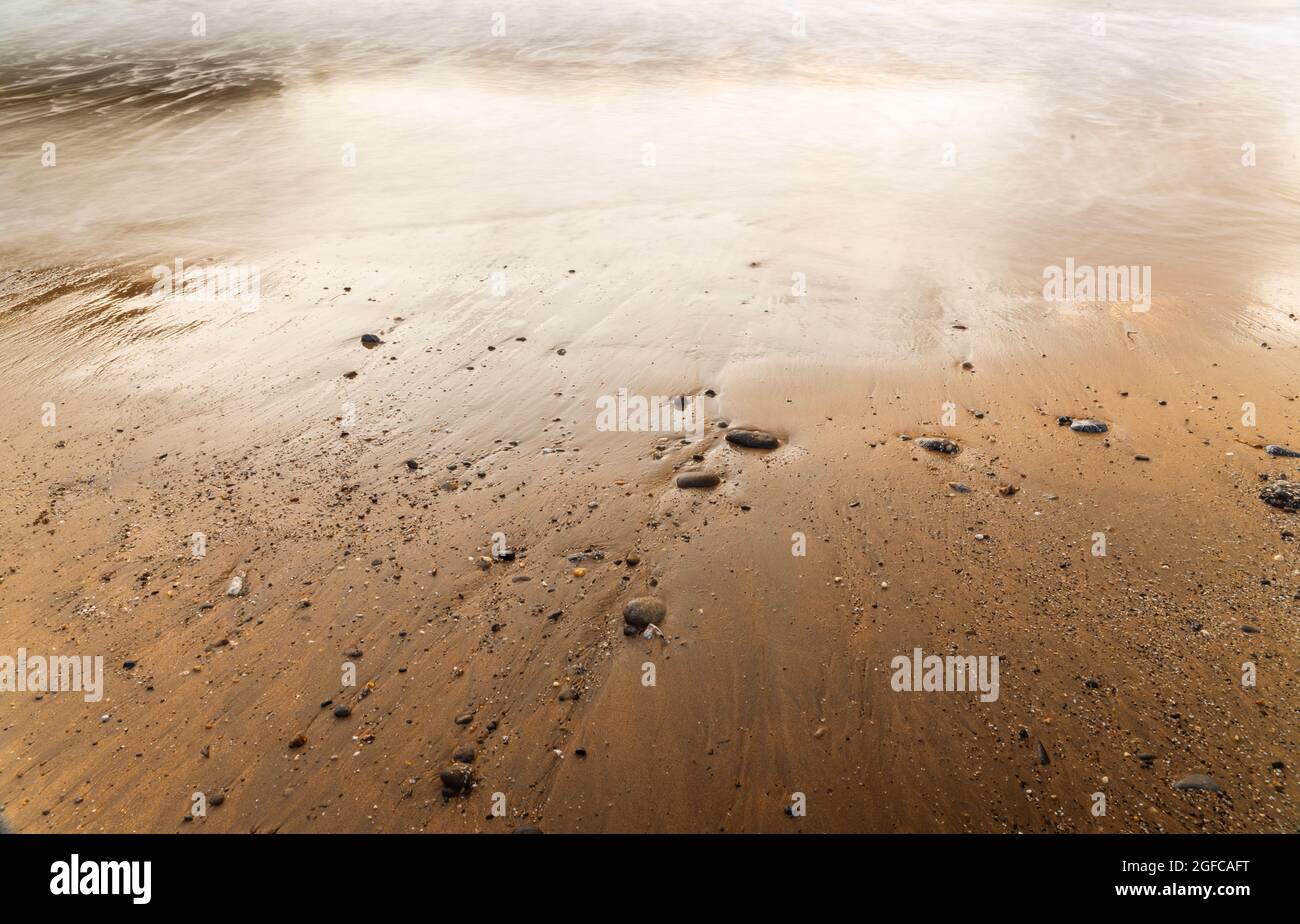backlit round pebble on a beach Stock Photo - Alamy
