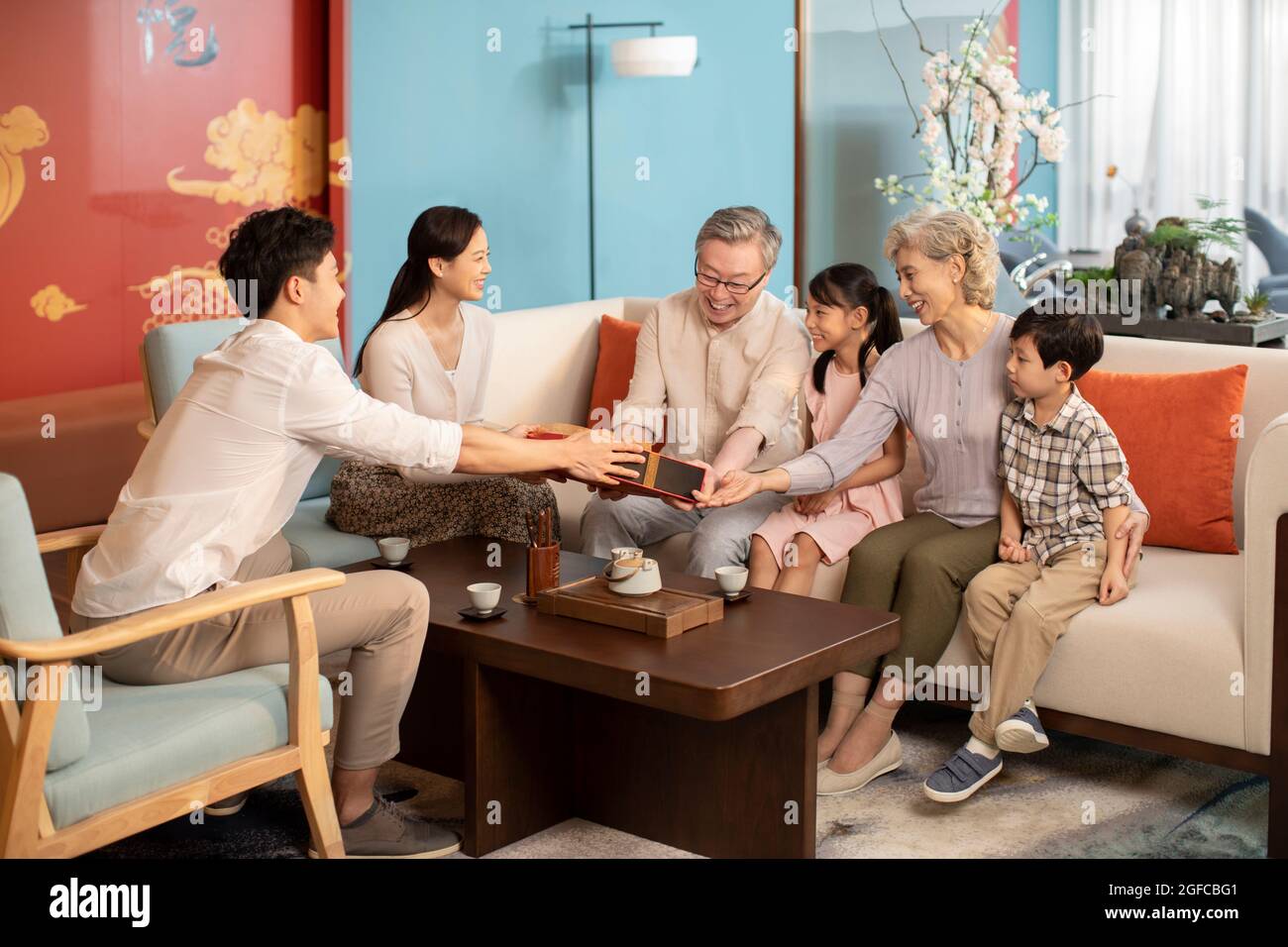 Son and daughter giving gift to father hi-res stock photography and ...
