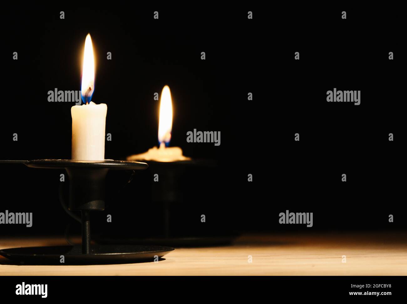 Beautiful black background with two lit candles Stock Photo - Alamy