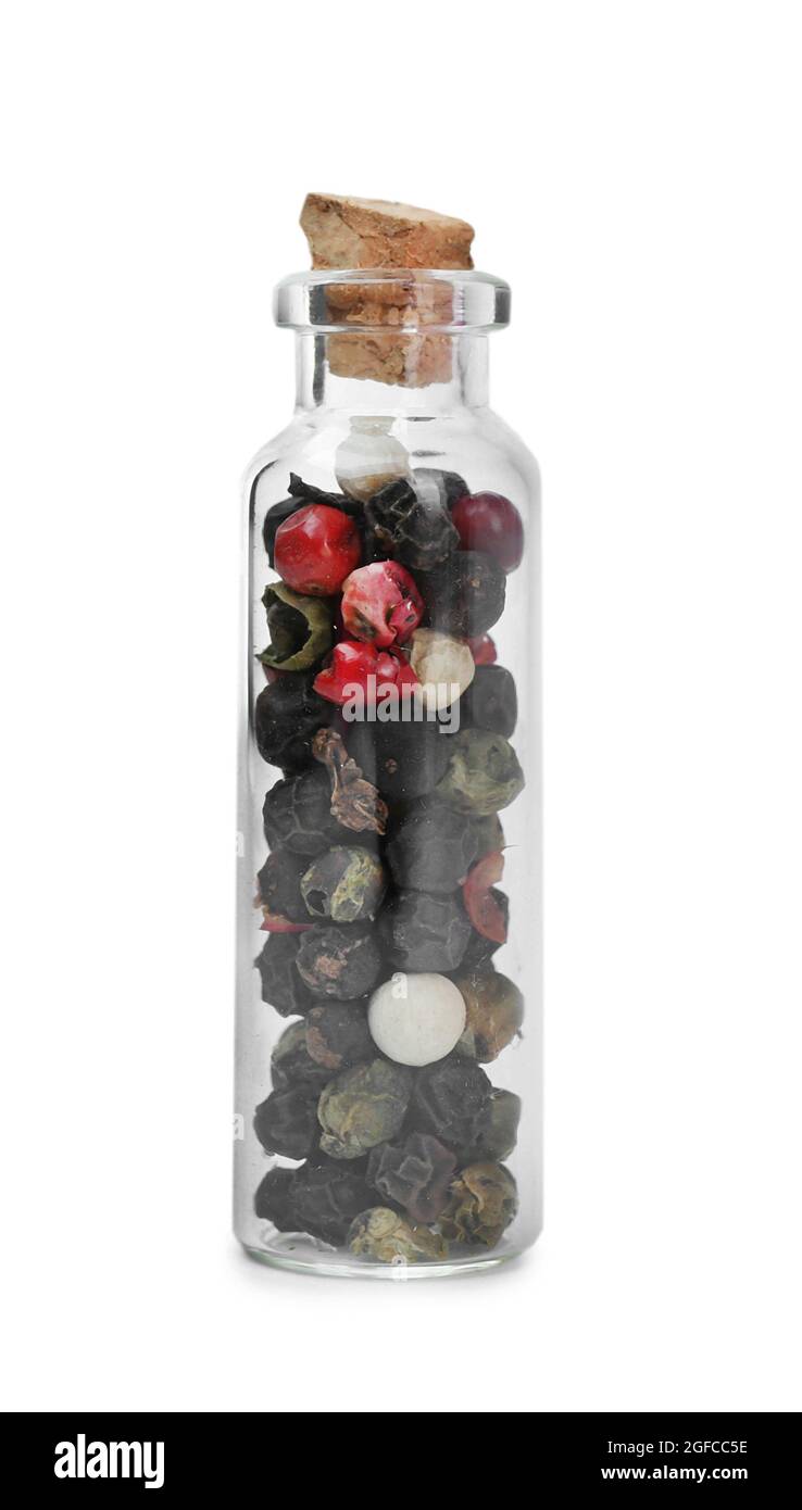 Aromatic allspice in glass bottle on white background Stock Photo - Alamy