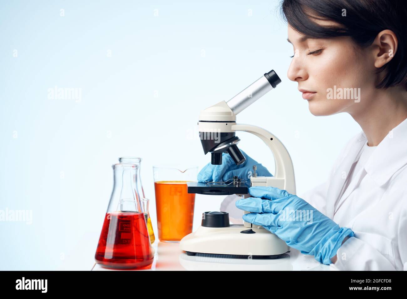 female doctor medical gown chemical solution microscope examination ...