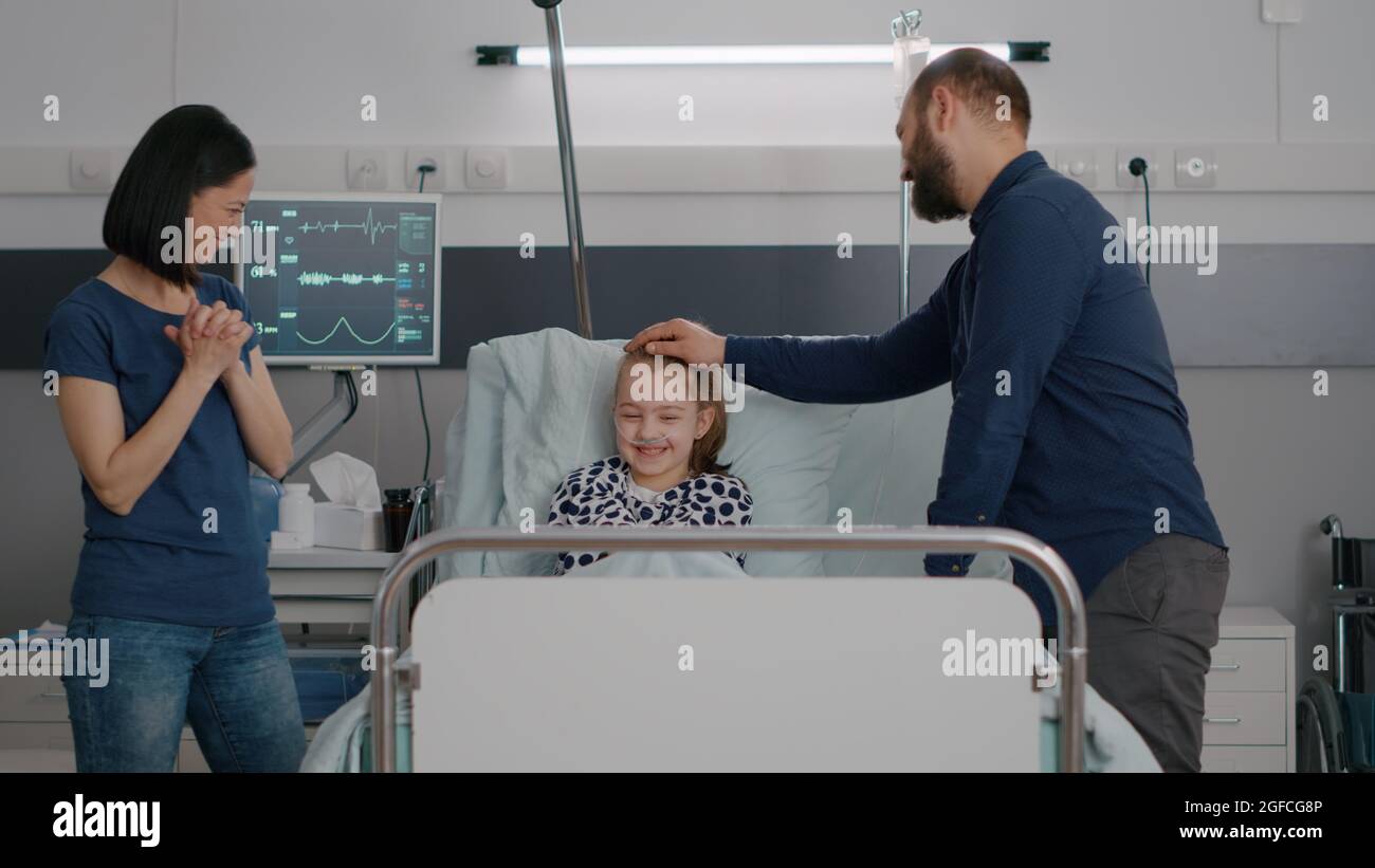 Happy family giving high five to little girl daughter recovering after ...