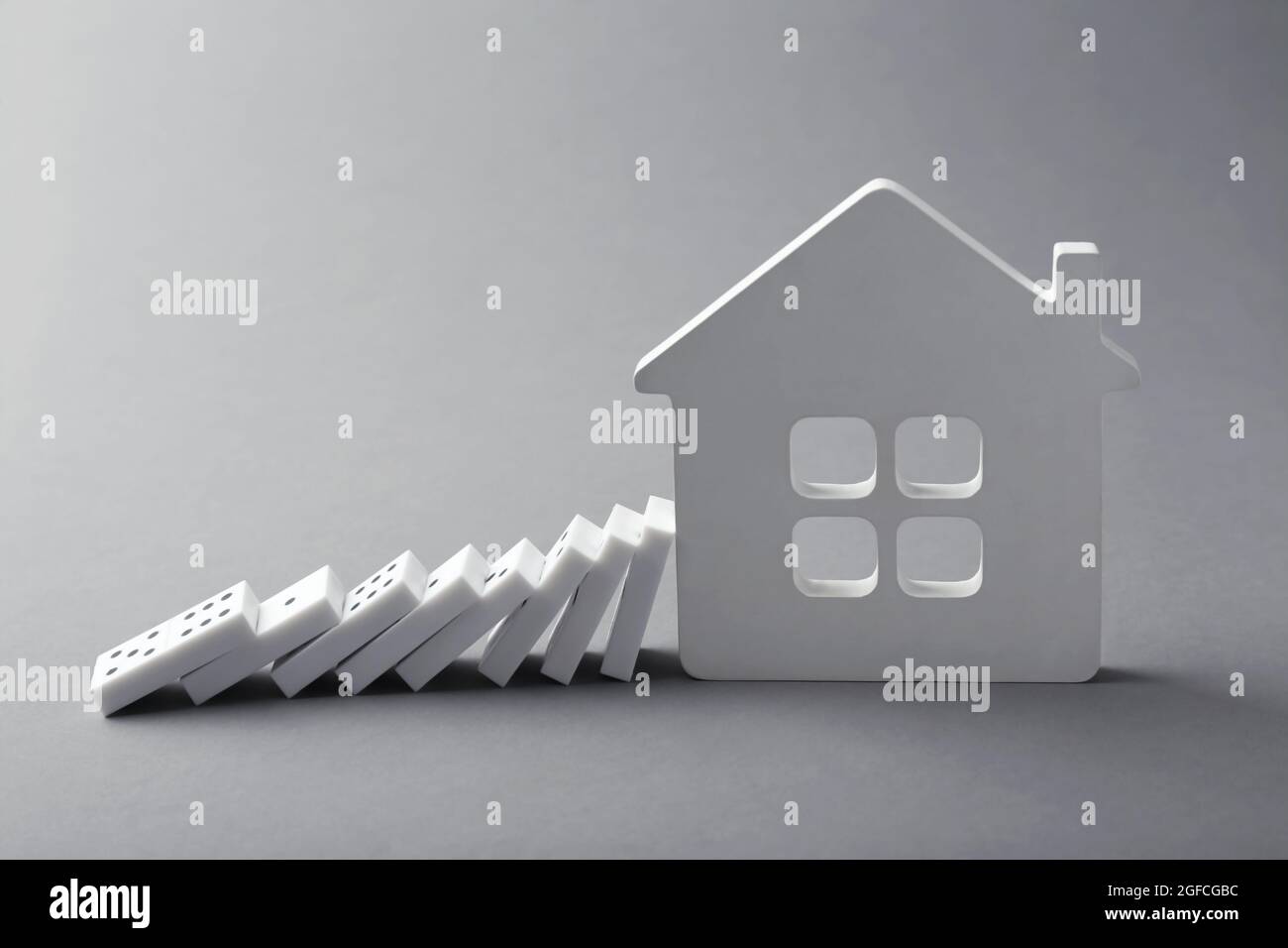 Dominoes and house shape on grey background Stock Photo - Alamy
