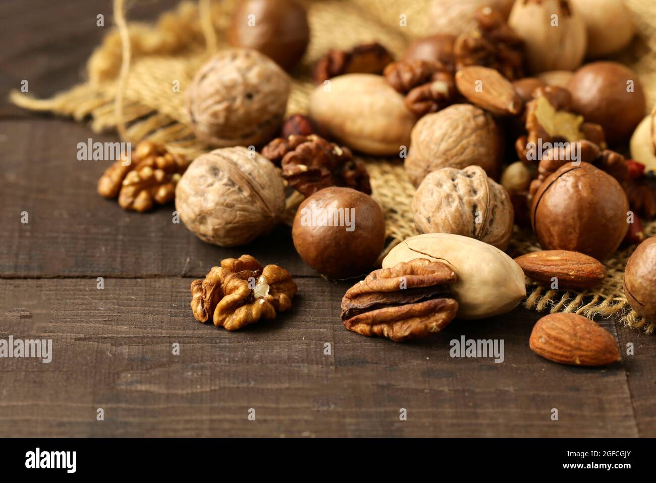 nuts mix on wooden background, healthy food Stock Photo - Alamy