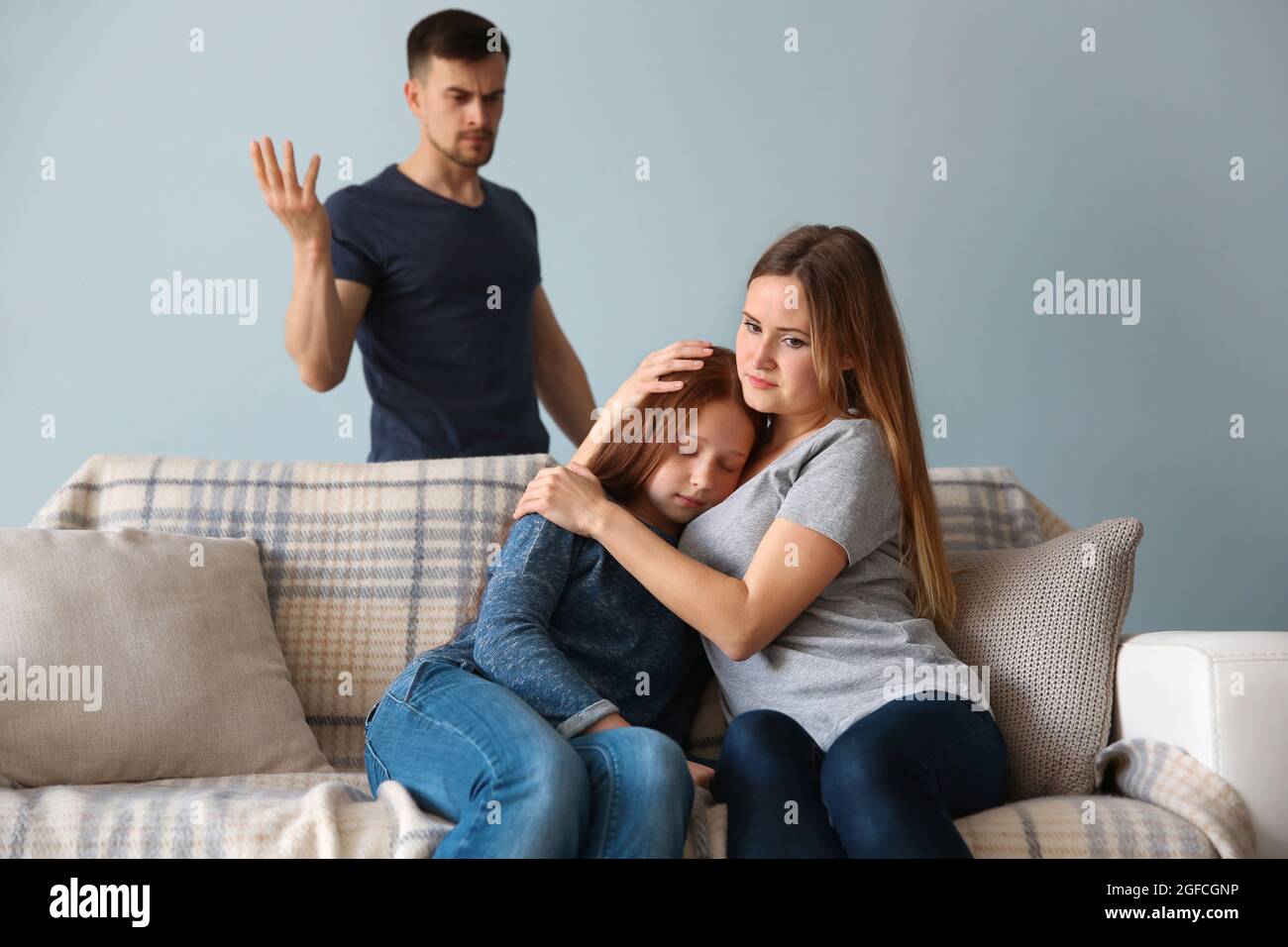 Family problems concept. Father abusing, but mother defending daughter ...