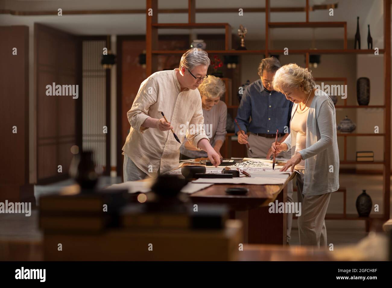 Happy friends practicing calligraphy together Stock Photo - Alamy