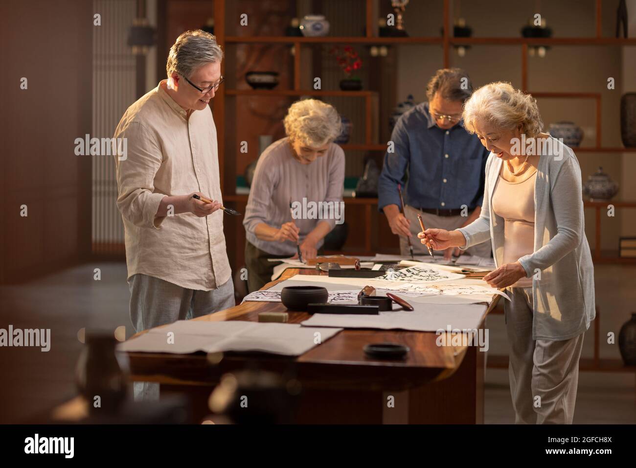 Happy friends practicing calligraphy together Stock Photo - Alamy