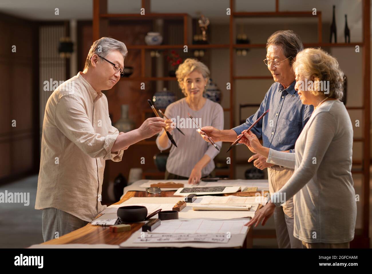 Happy friends practicing calligraphy together Stock Photo - Alamy