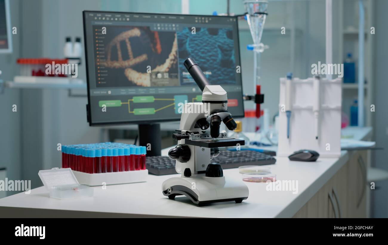 Scientific microscope on laboratory desk with researching instruments ...