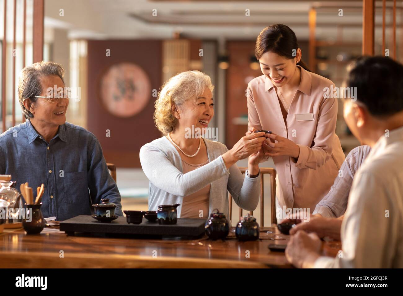 Happy friends drinking tea together Stock Photo - Alamy