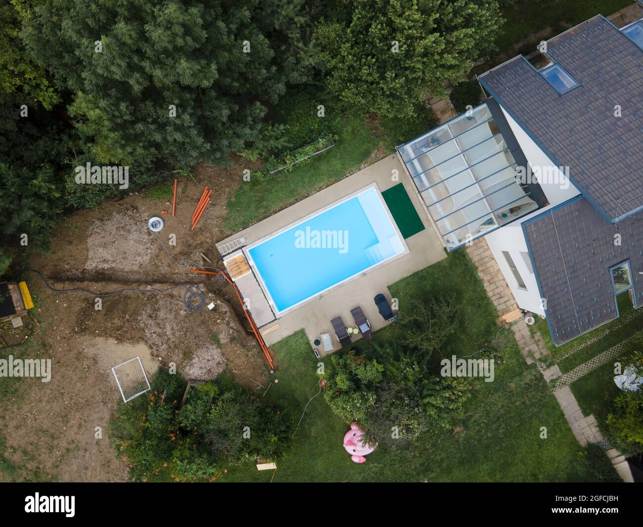 aerial drone flight of pool build construction site with pool filled ...