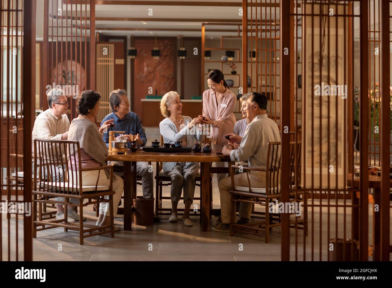 Happy friends drinking tea together Stock Photo - Alamy