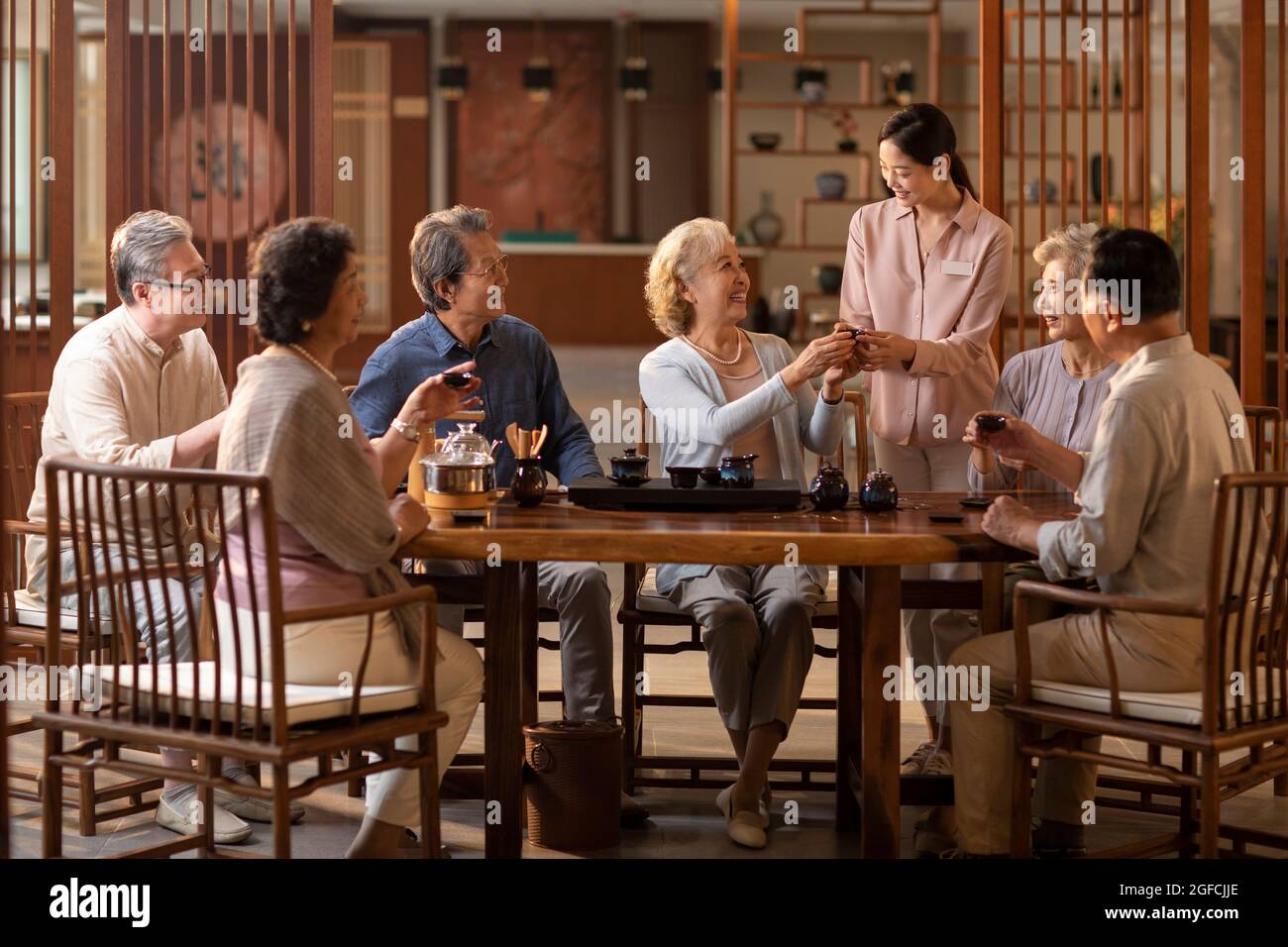 Happy friends drinking tea together Stock Photo - Alamy