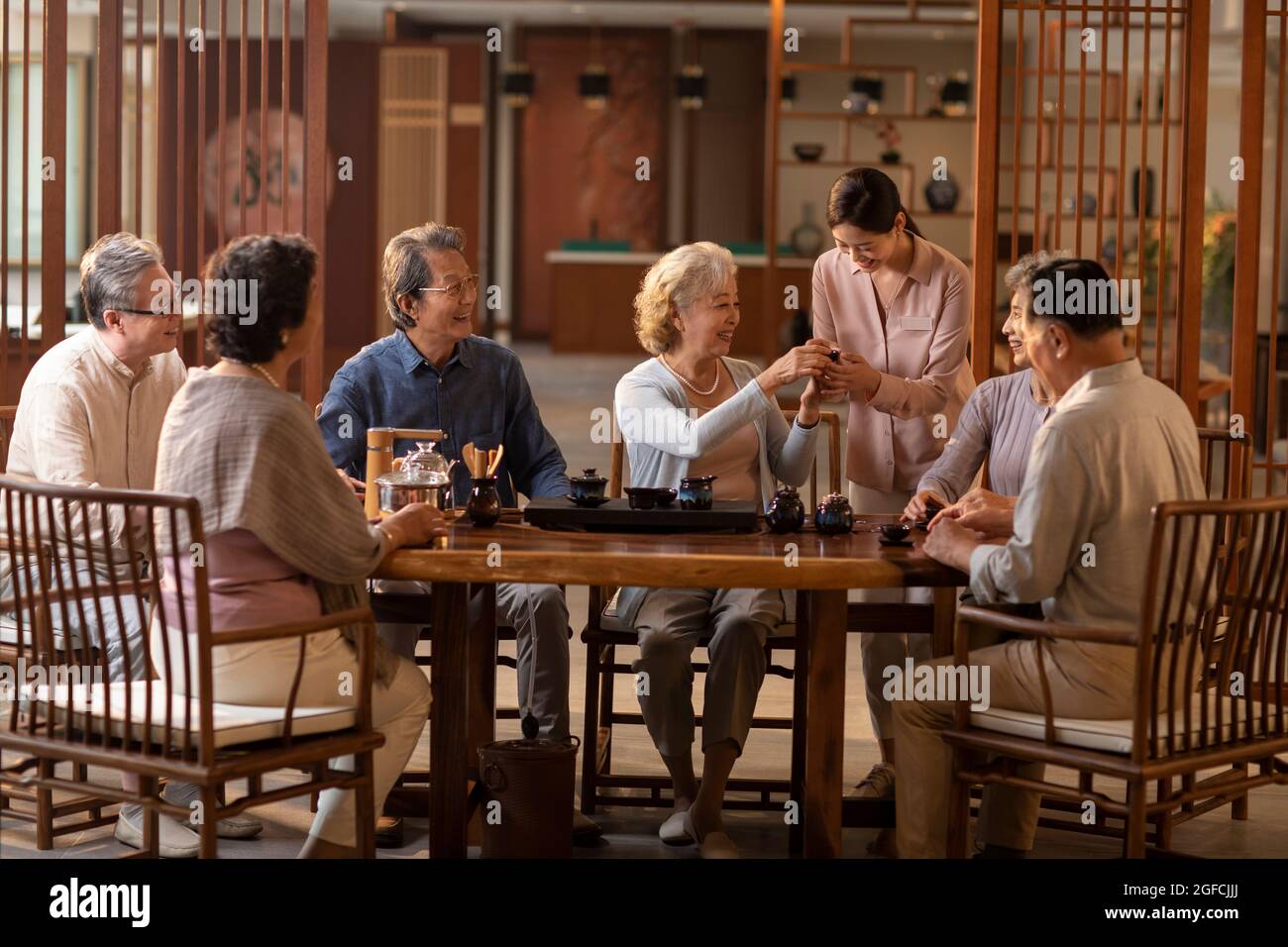 Happy friends drinking tea together Stock Photo - Alamy