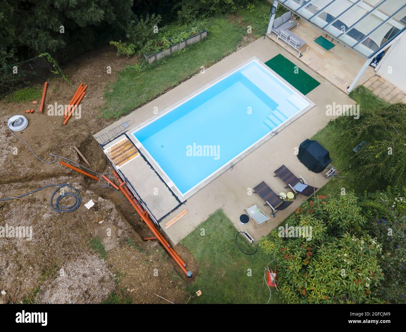 aerial drone flight of pool build construction site with pool filled ...